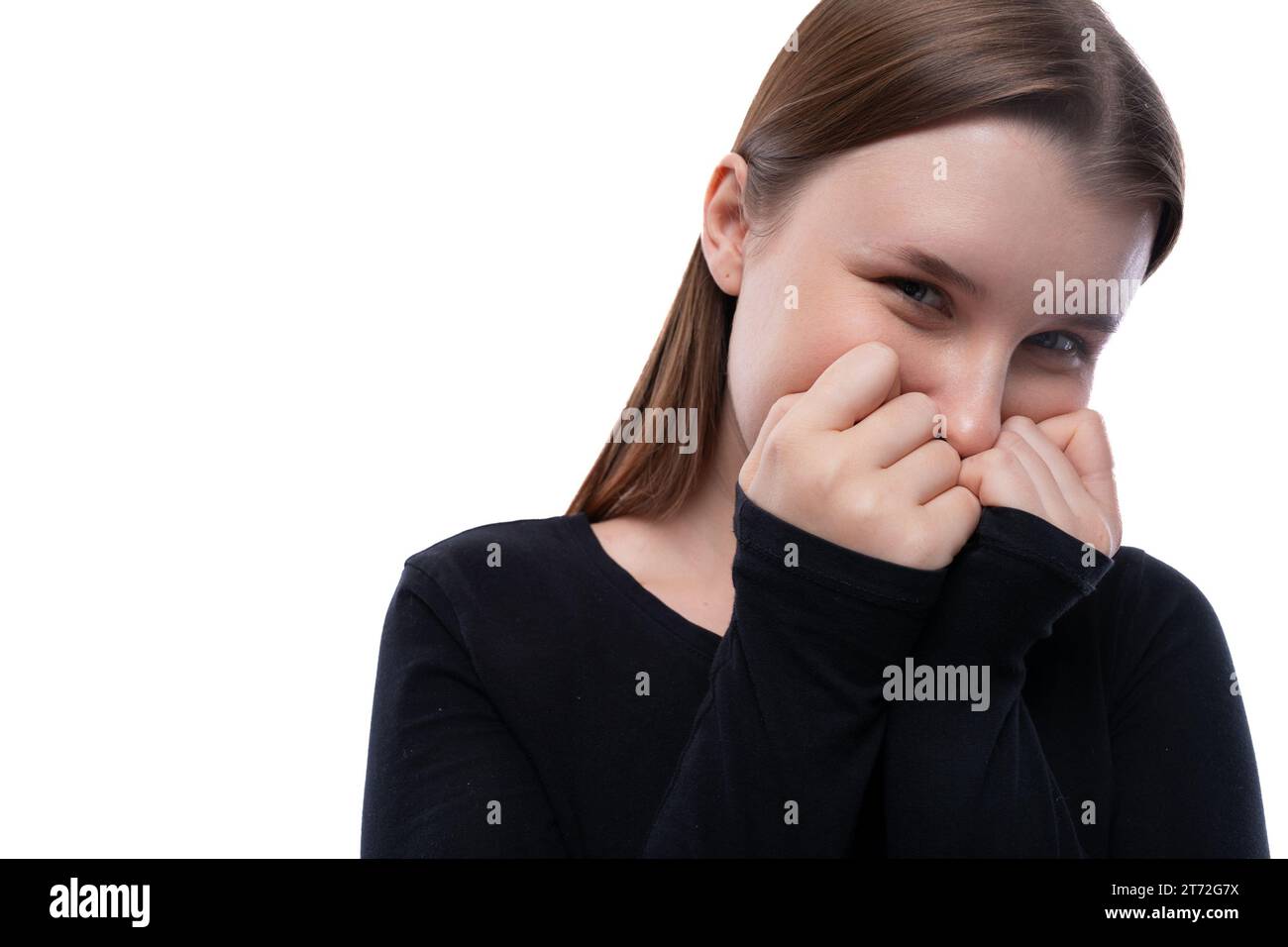 Shy school-age girl with brown hair on a white studio background Stock ...