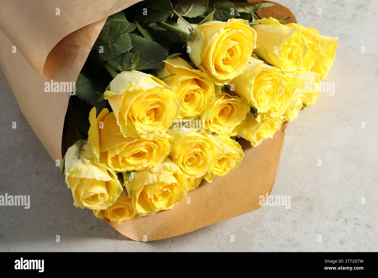 Beautiful bouquet of yellow roses on light grey table, closeup Stock ...