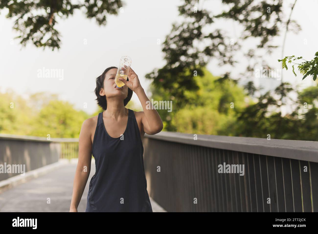 Sporty woman drinking water walking hi-res stock photography and images ...