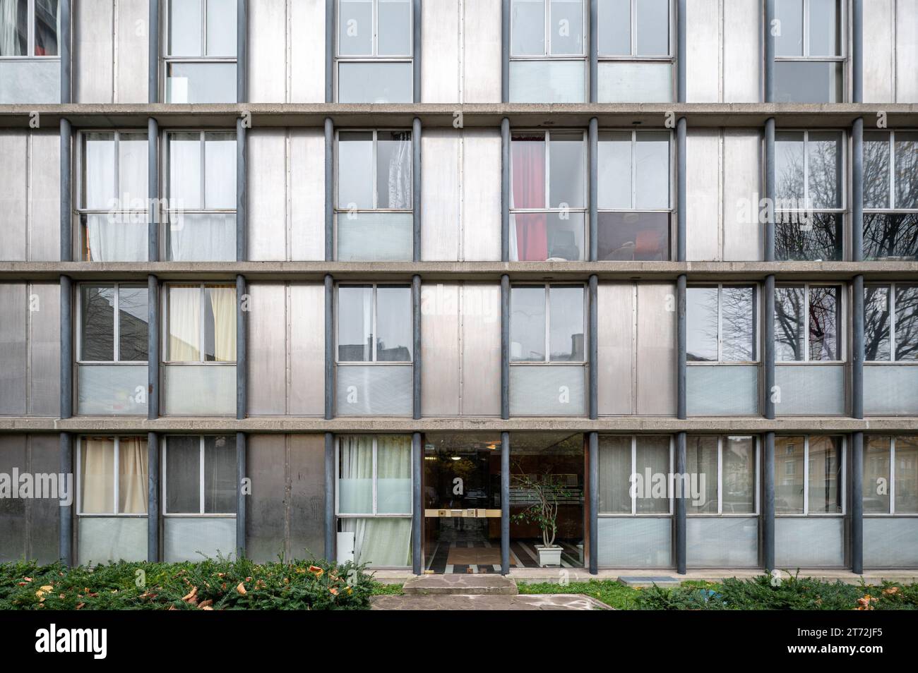 An exterior view of a modern multi-level apartment complex featuring a ...