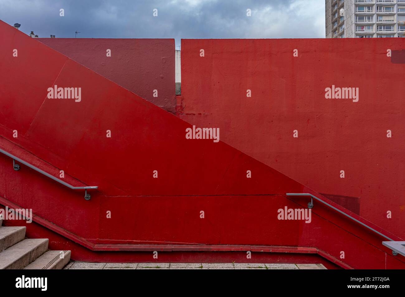 View of a graphic red wall and staircase with steps and ramp in the ...