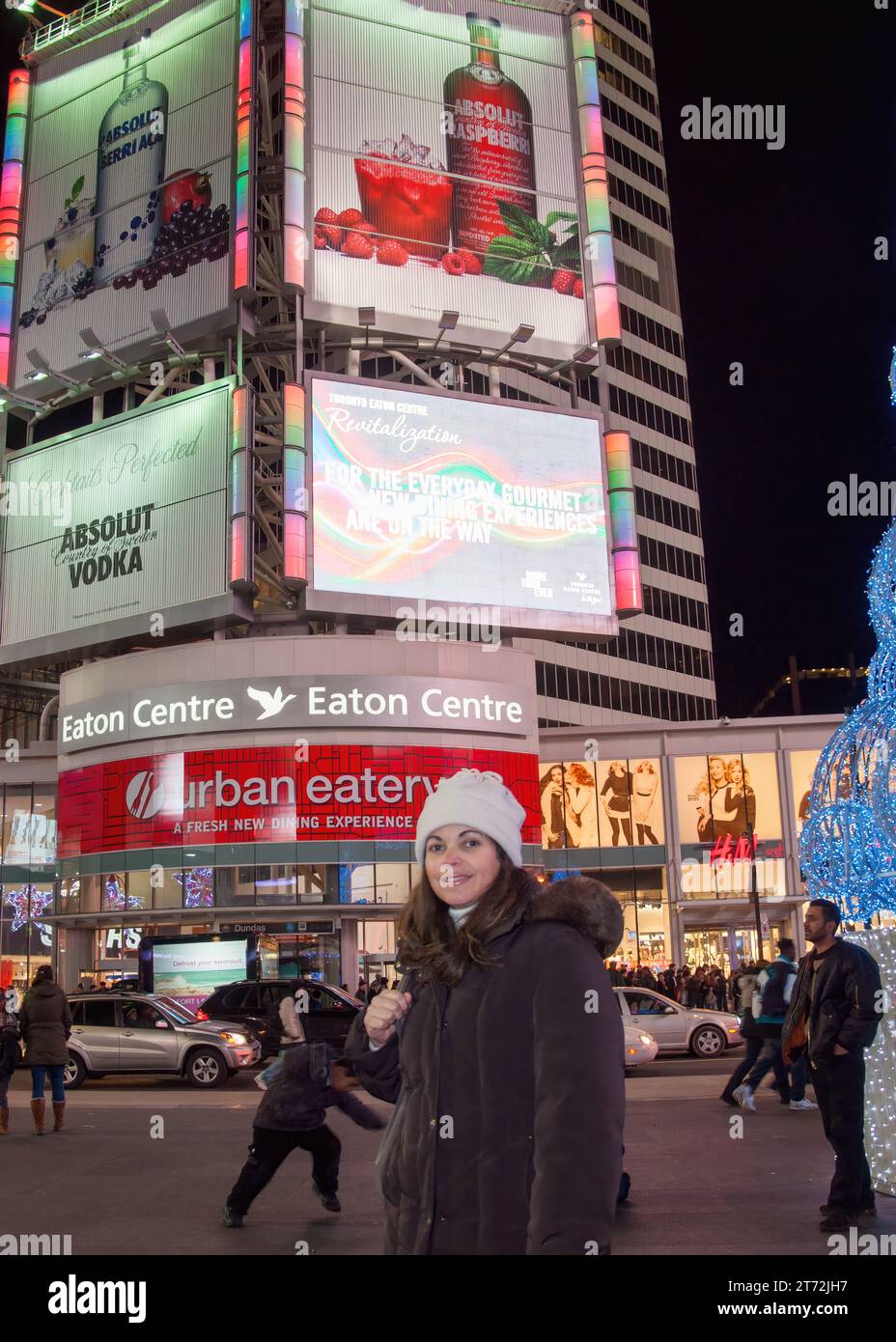 Toronto, Canada, night portrait of a woman by the advertisements ...