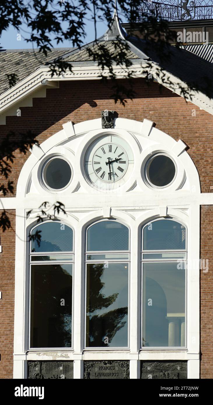 A close-up shot of a clock face affixed to the exterior wall of a large ...