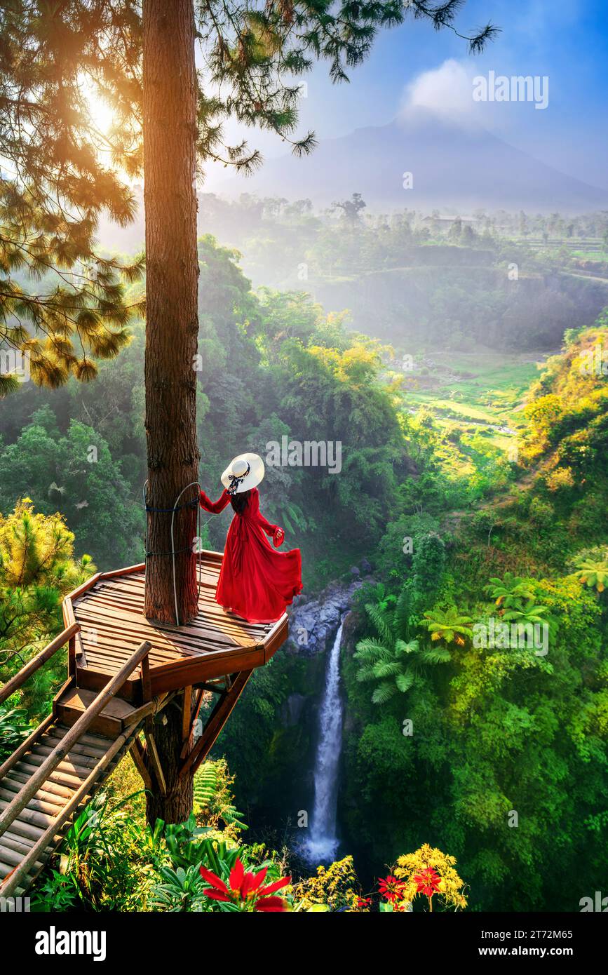 Tourist standing at Air Terjun Kedung Kayang waterfall at sunrise ...