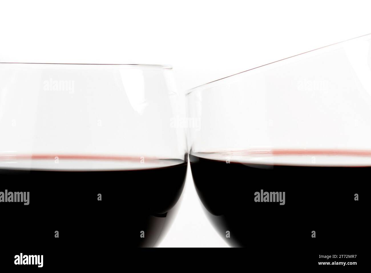 two glasses of wine make cheers on white background Stock Photo - Alamy