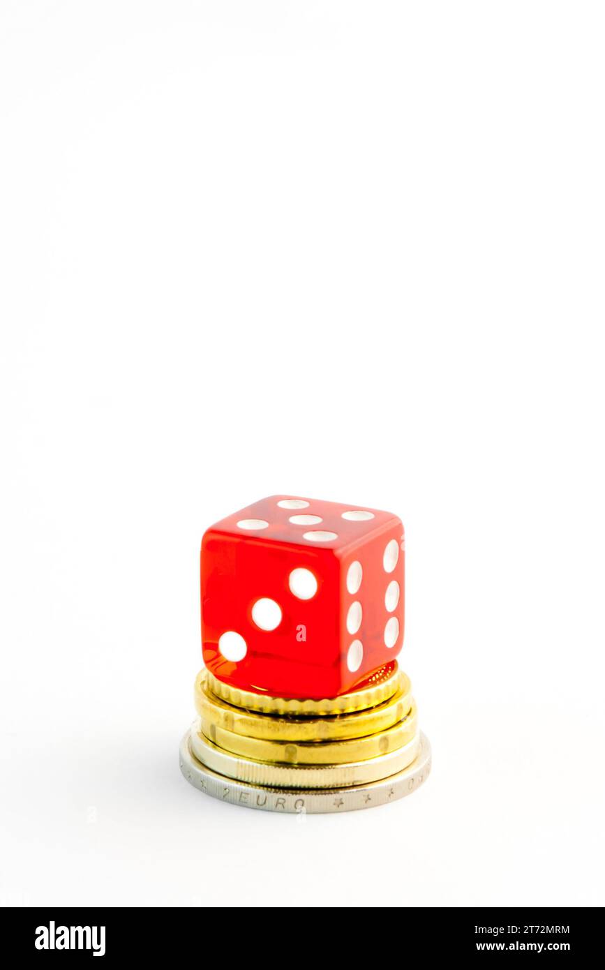 one red dice on pile of euro coin on white background Stock Photo - Alamy