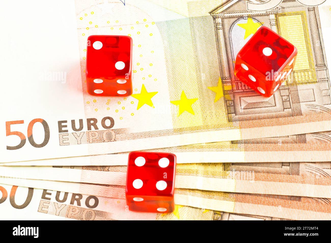 view from top of three red dice on the 50-euro banknotes Stock Photo ...