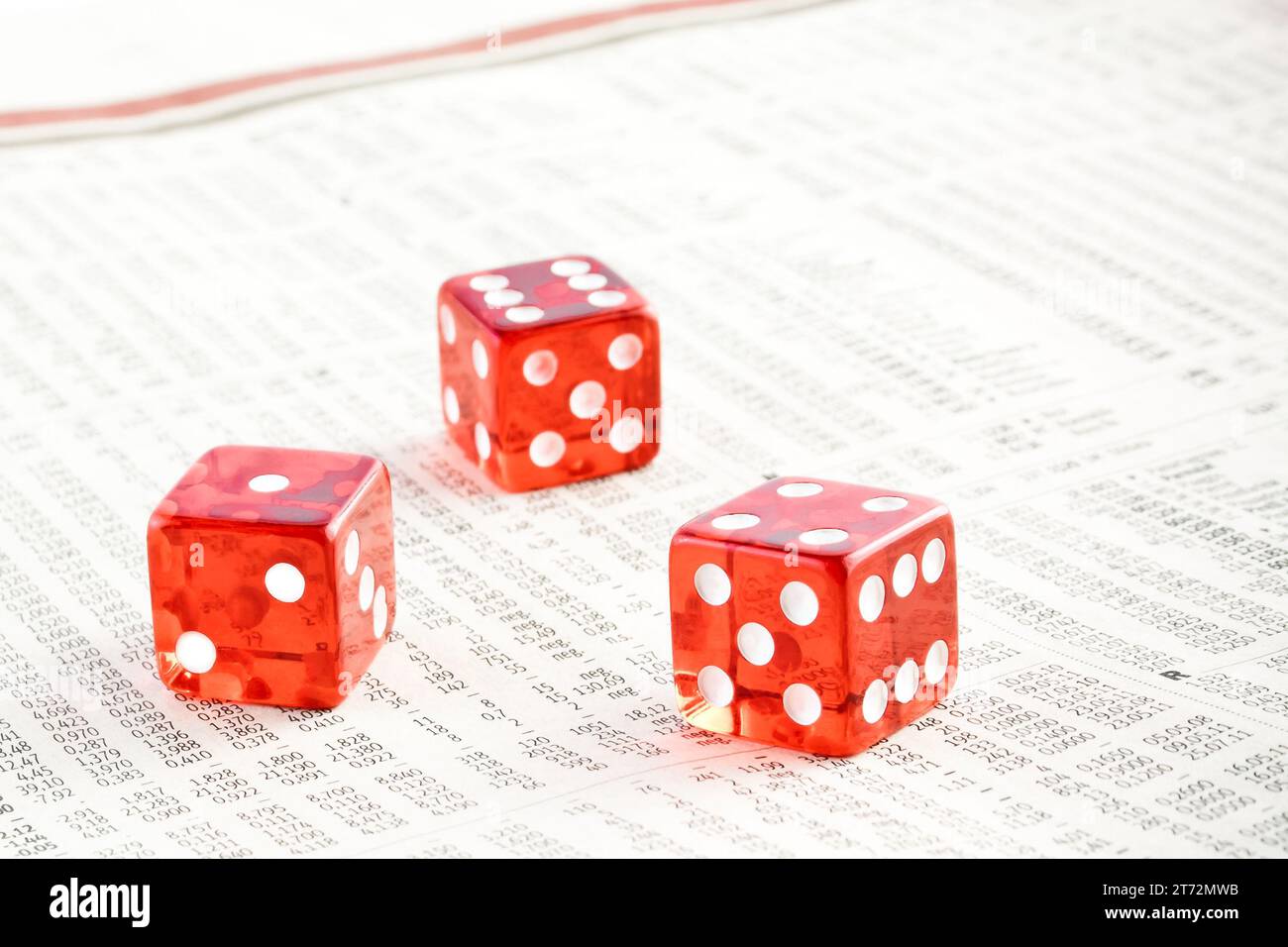 detail of three red dice on the financial newspaper Stock Photo - Alamy