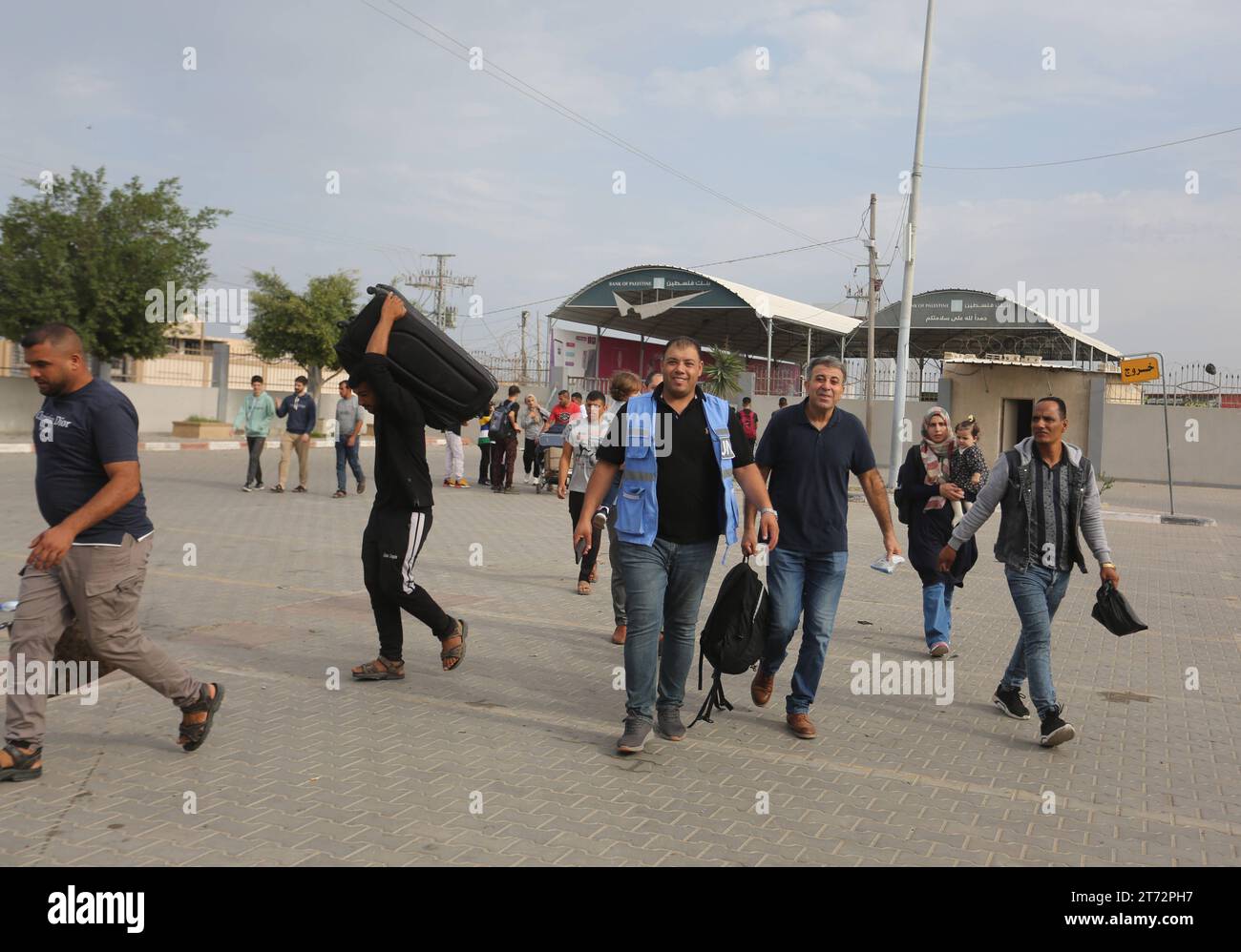 People walk on the Palestinian side of the Rafah border crossing with ...