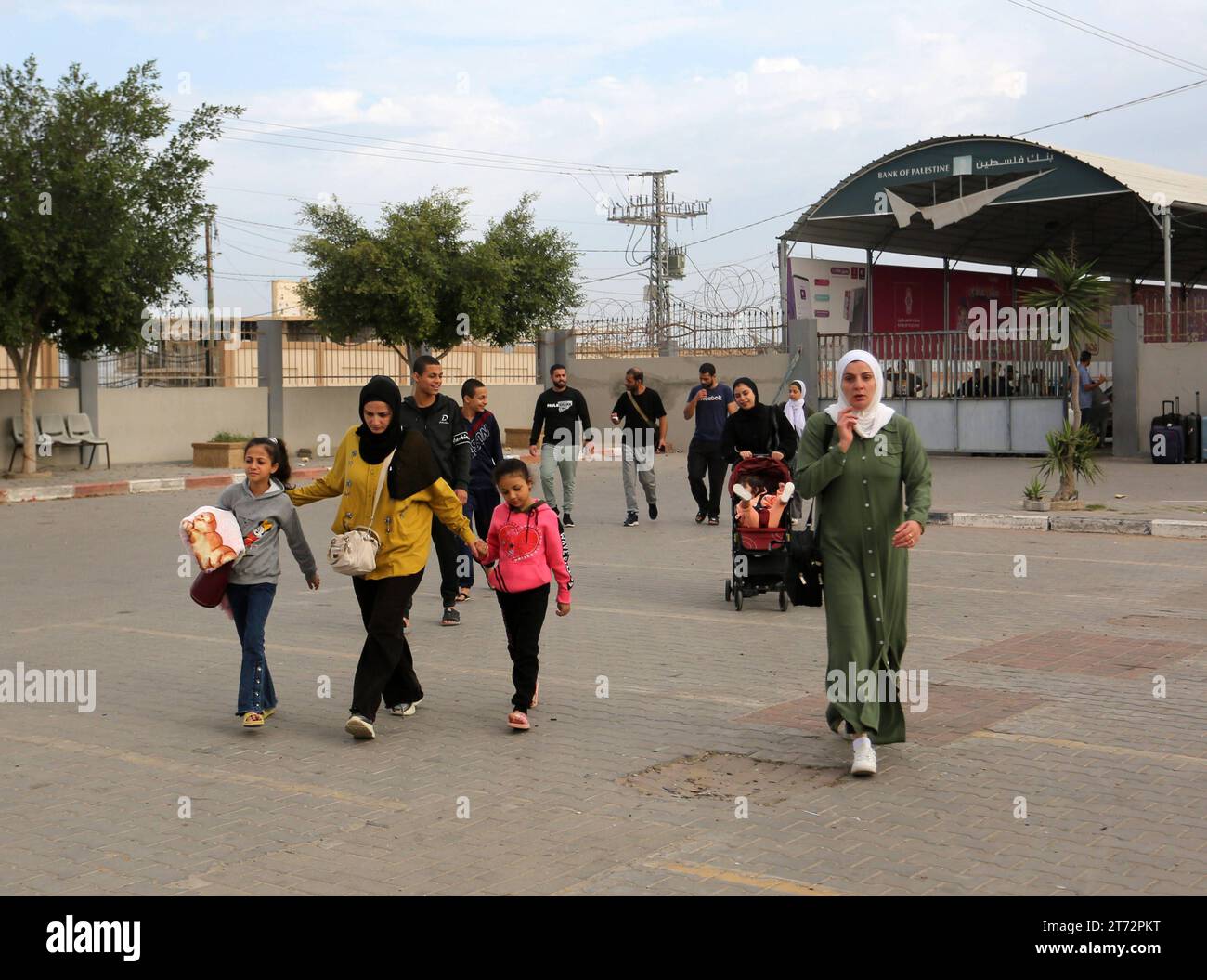 People walk on the Palestinian side of the Rafah border crossing with ...