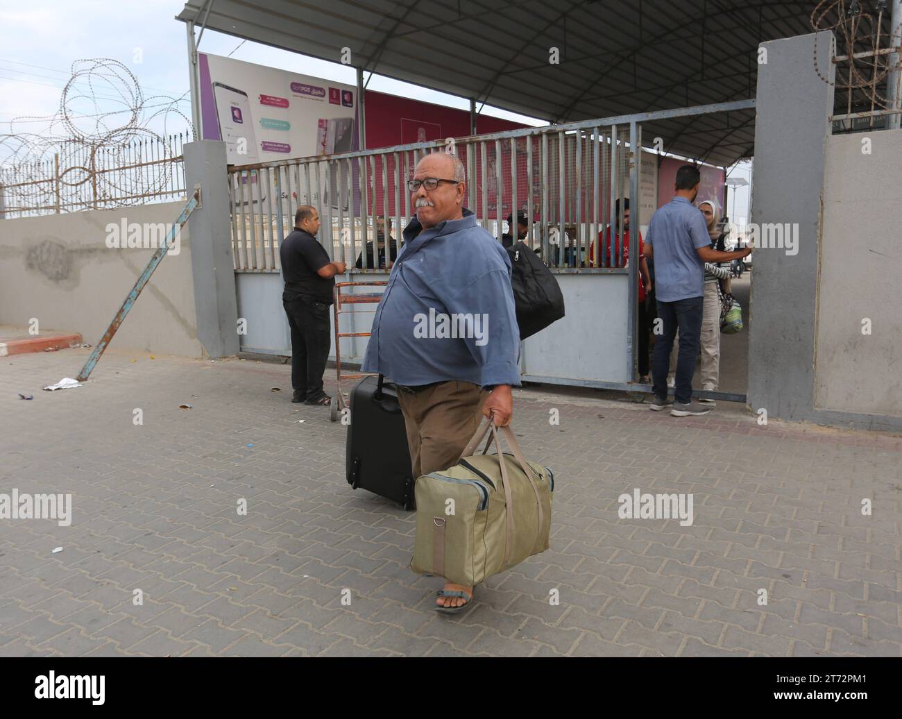 People walk on the Palestinian side of the Rafah border crossing with ...