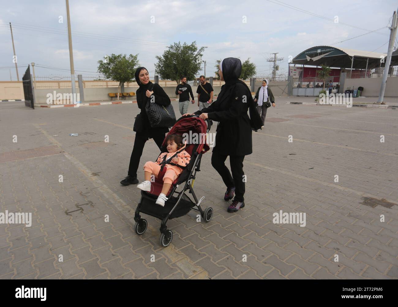People walk on the Palestinian side of the Rafah border crossing with ...