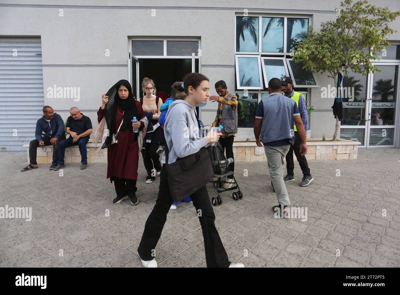 People walk on the Palestinian side of the Rafah border crossing with ...