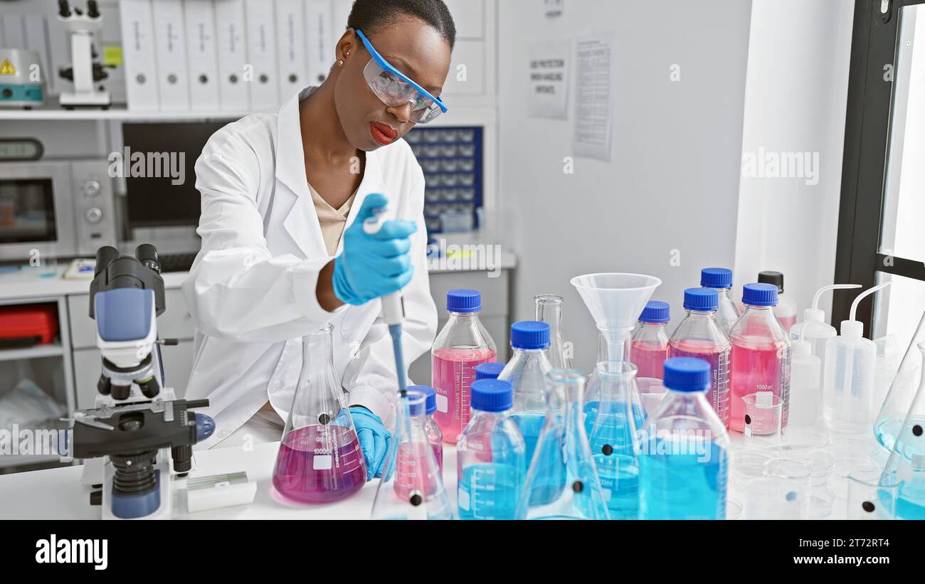 Black beauty in lab goggles, focused african american woman scientist ...