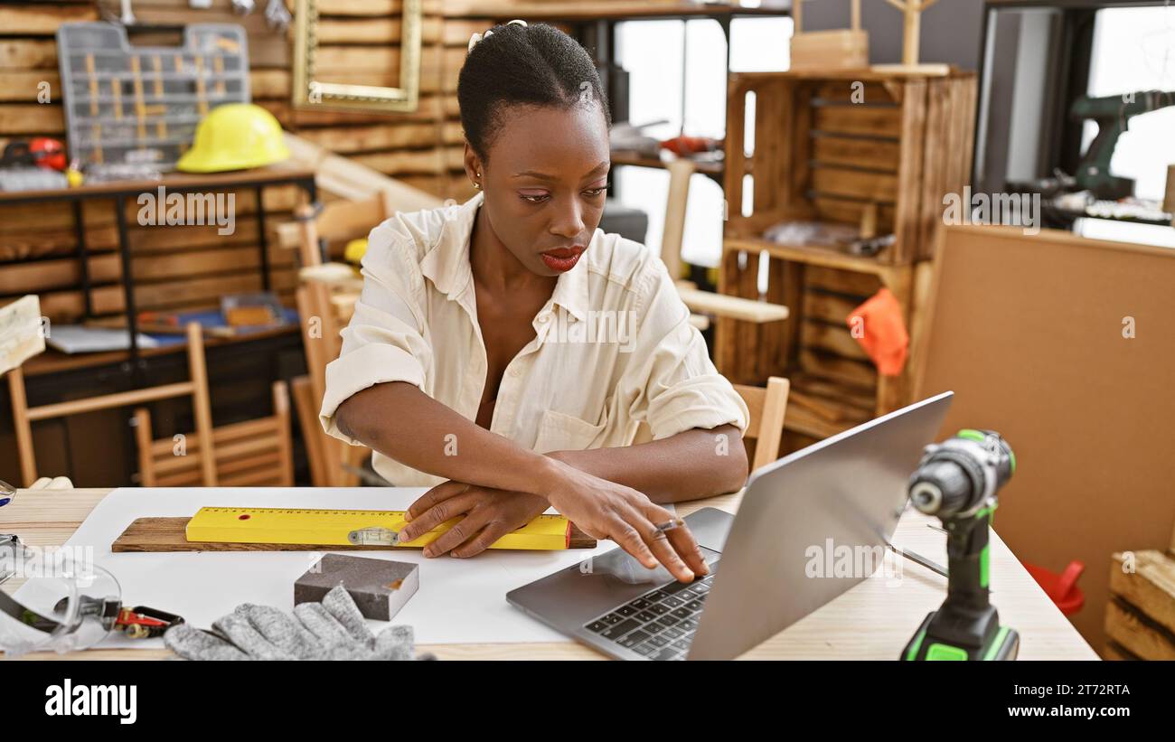 Beautiful african american woman carpenter skillfully measuring wood ...