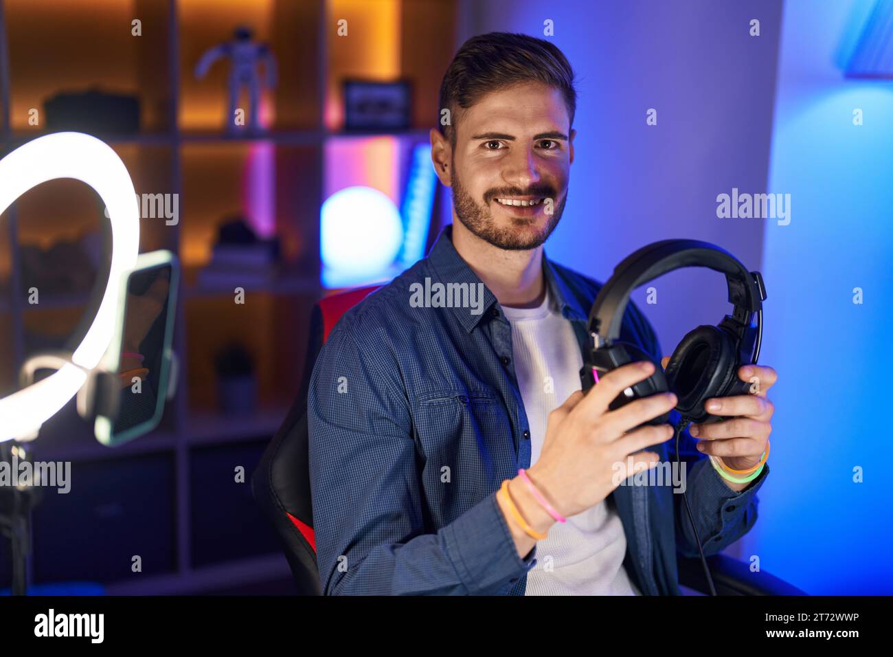 Young caucasian man streamer smiling confident holding headphones at ...