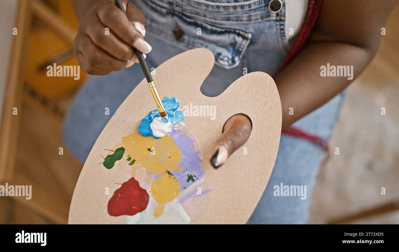In a heartwarming indoor art class, an african american woman artist ...