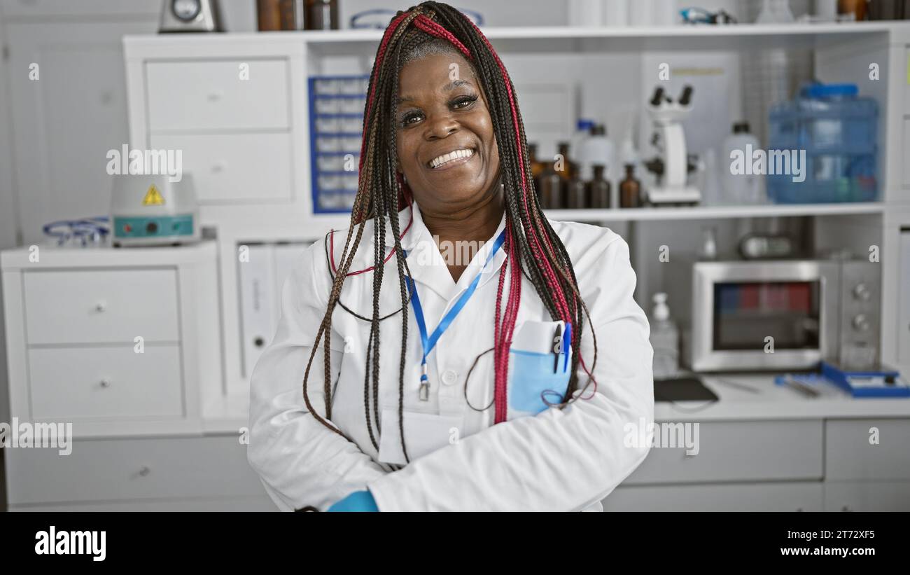 Confident african american woman scientist with braids, smiling ...