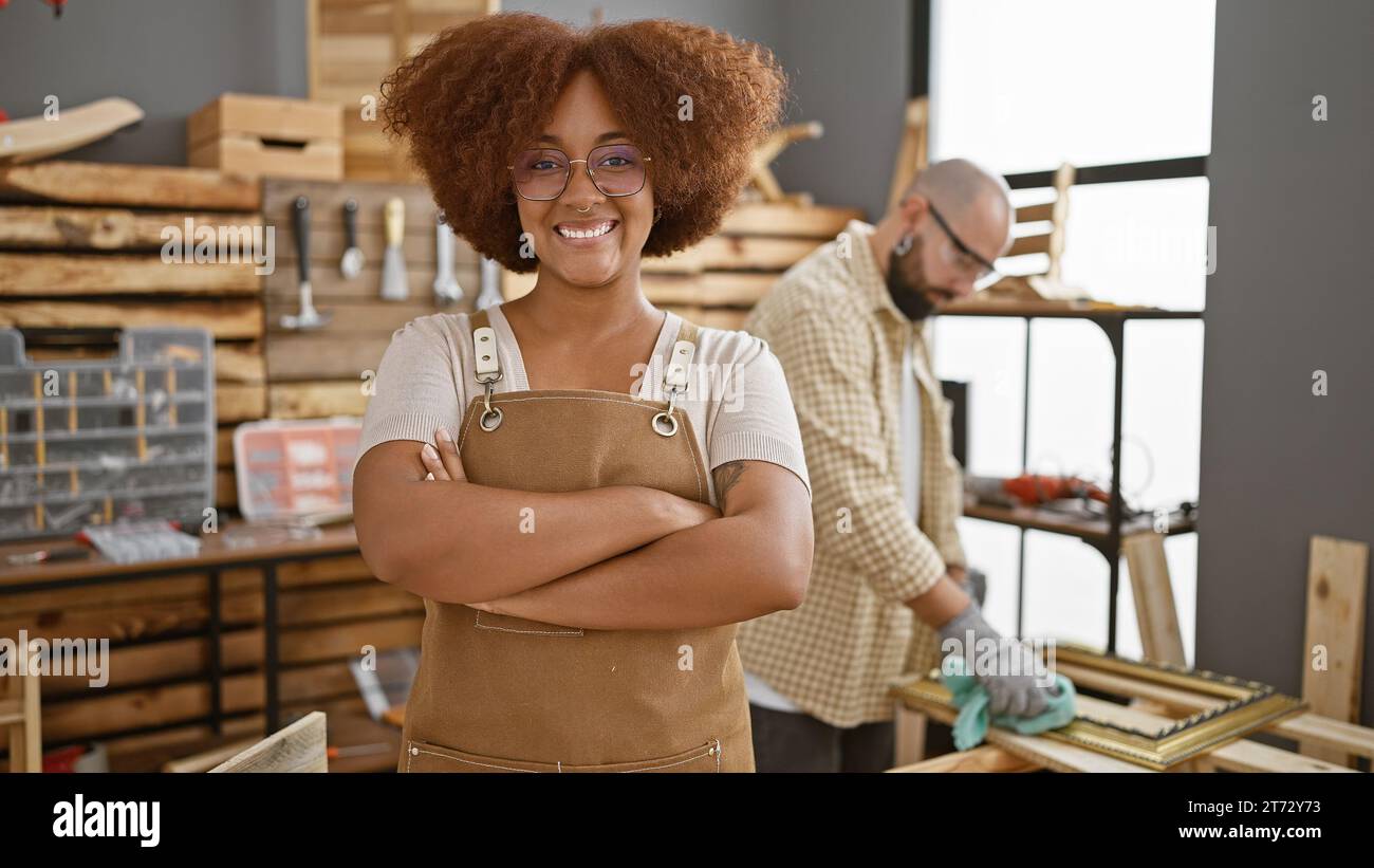 Two relaxed carpenter partners, man and woman, standing with crossed ...