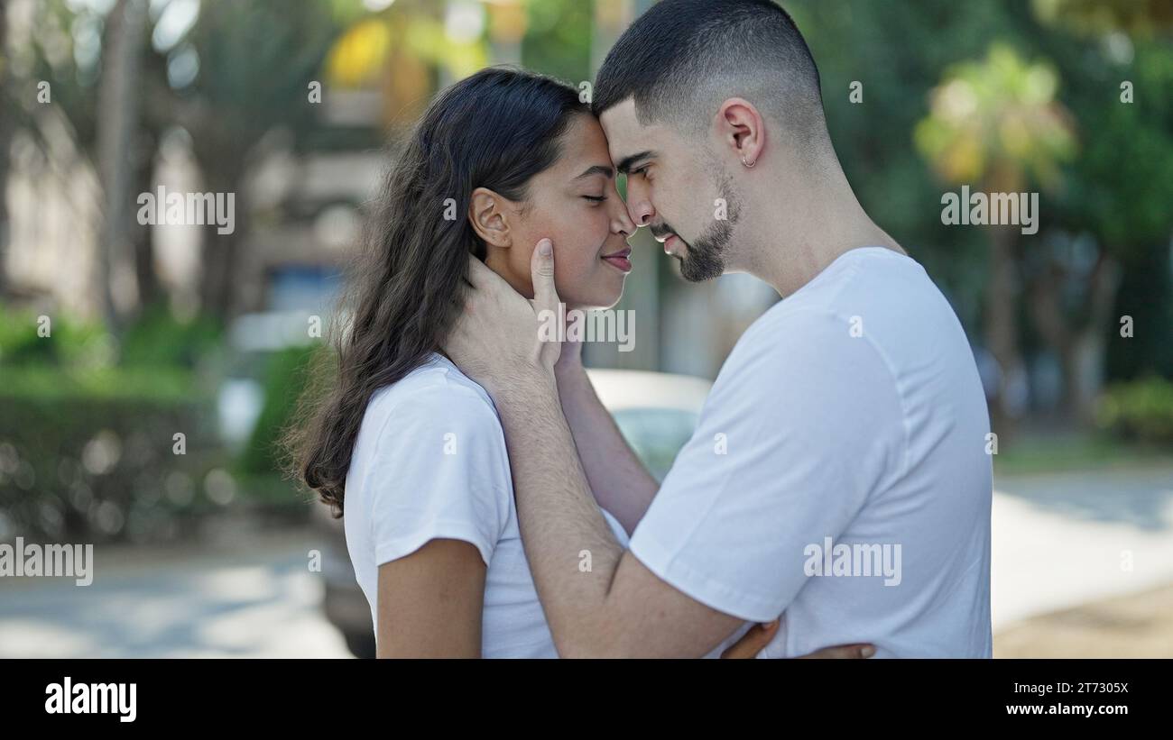 Beautiful, confident couple, smiling and hugging, deeply looking into ...