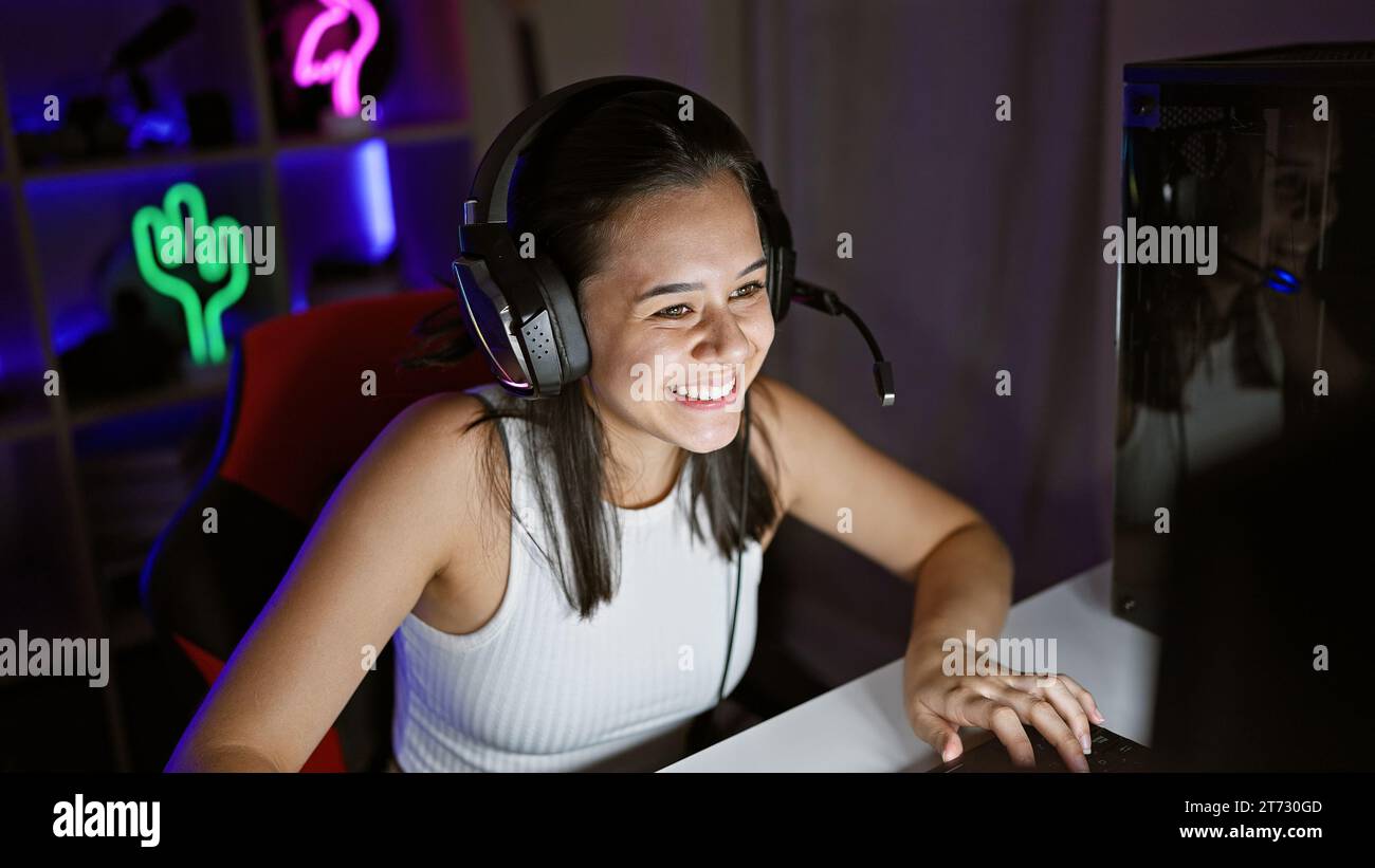 Young beautiful hispanic woman streamer playing video game using ...