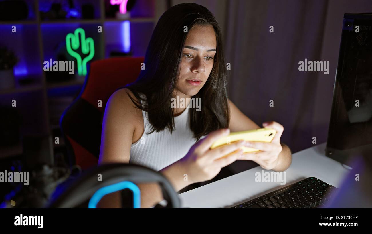 Gorgeous young hispanic woman streamer, passionately immersed in ...