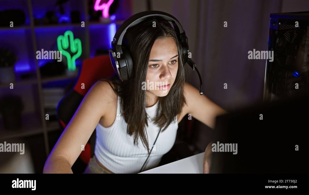 Young beautiful hispanic woman streamer playing video game using ...
