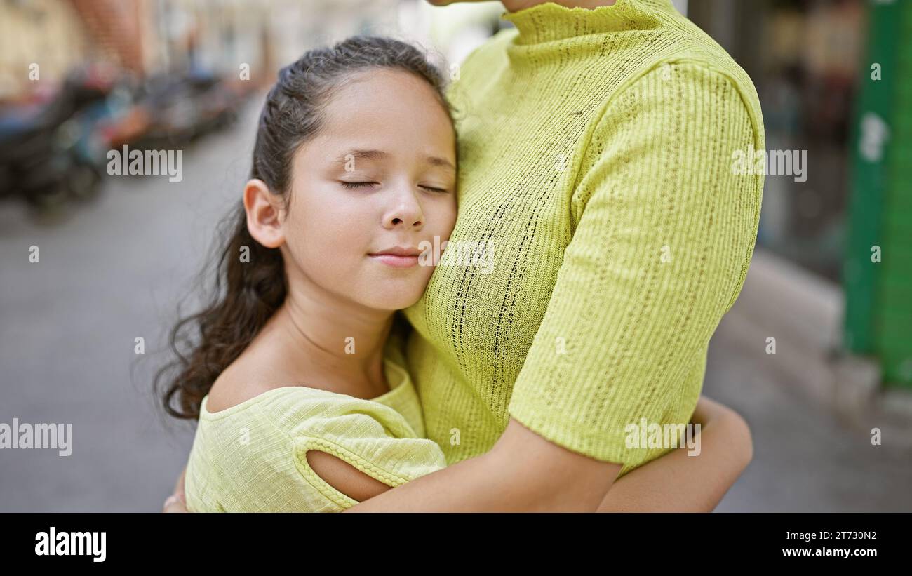 Urban mother-daughter love, a cool lifestyle expression of hugging in ...