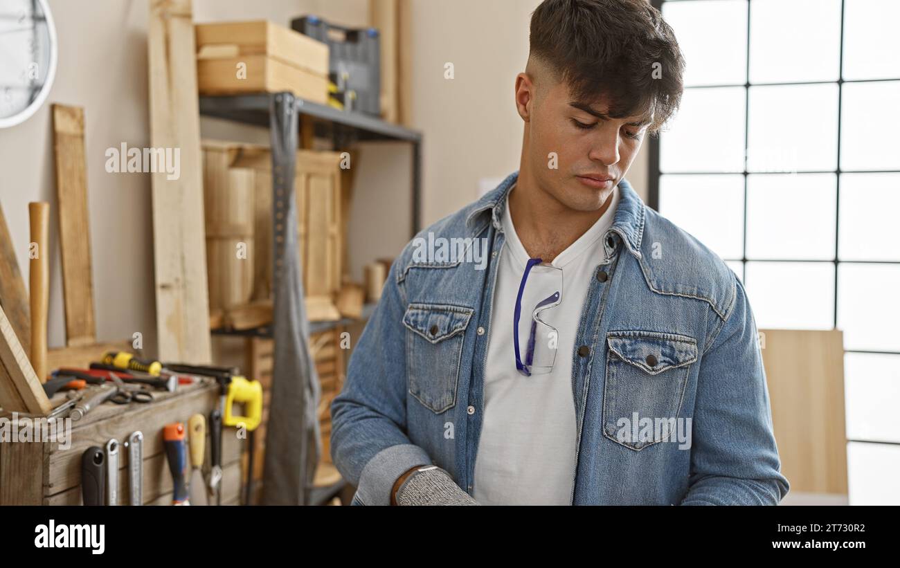 Handsome young hispanic man, a serious-faced professional carpenter ...