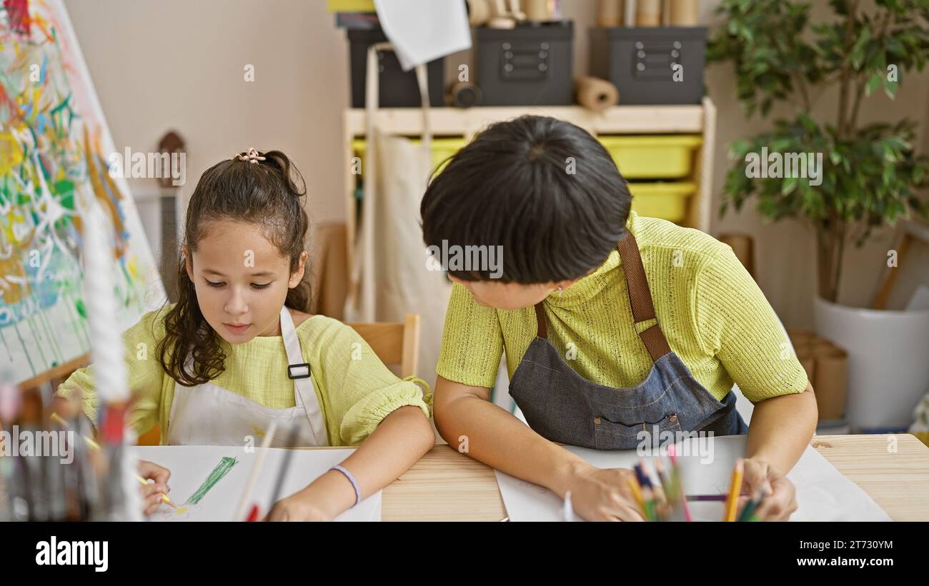 Artist teacher and student drawing on canvas together in art studio ...