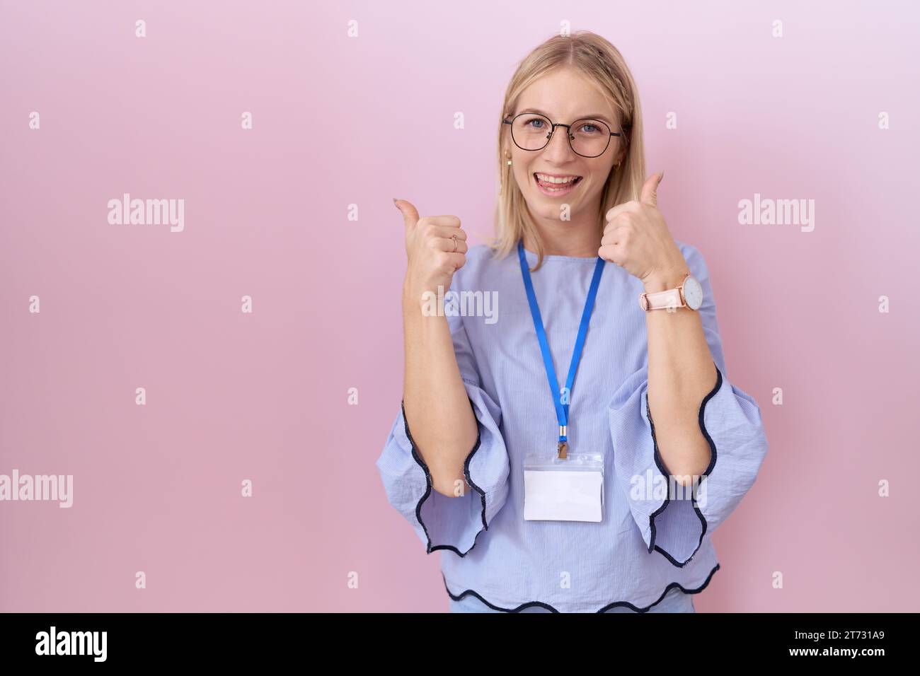 Young caucasian business woman wearing id card success sign doing ...