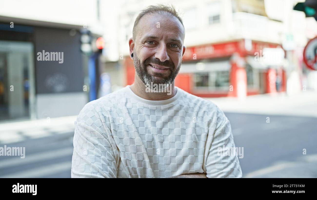 Cool, confident young man standing on street, smiling with joy - a ...
