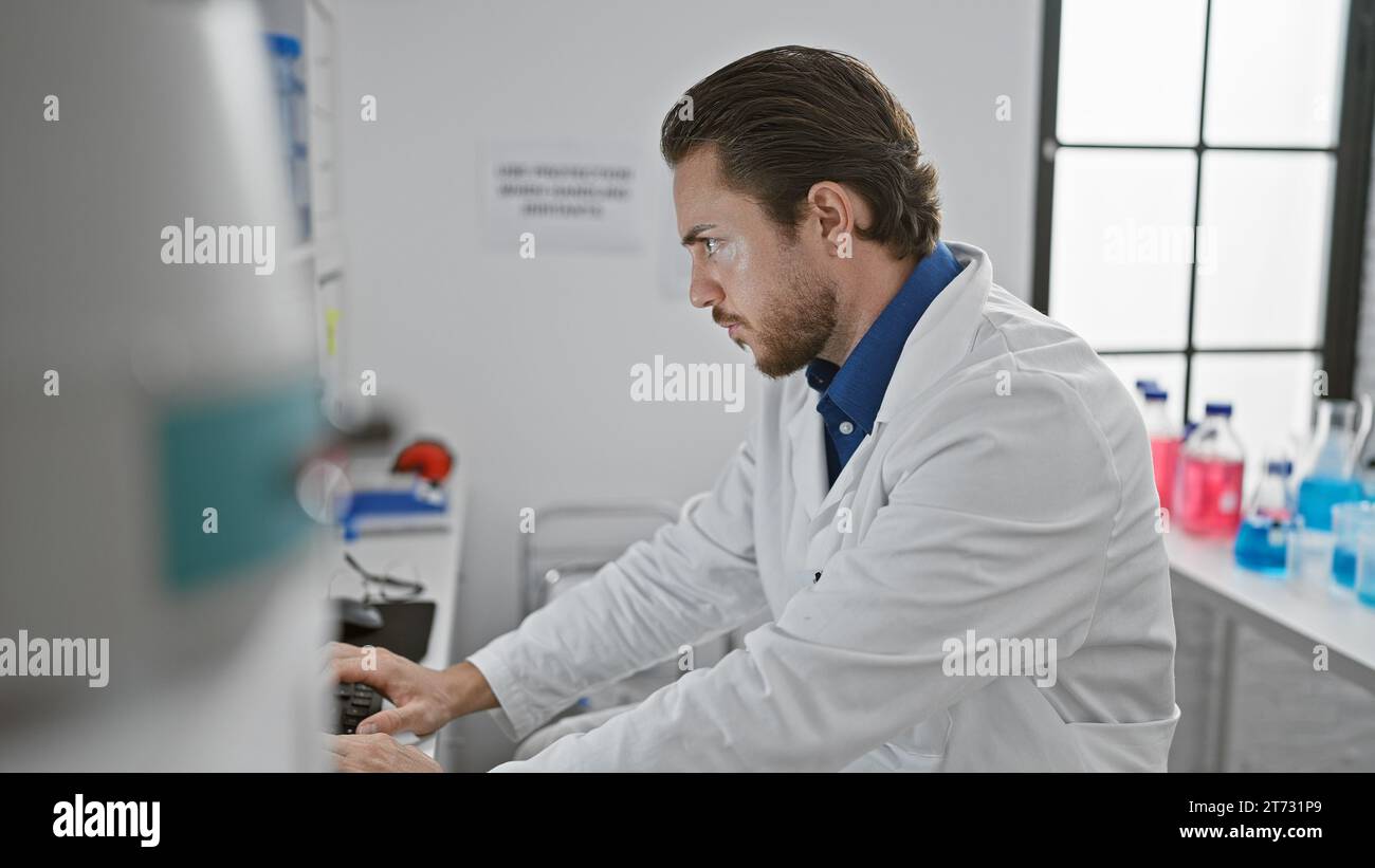 Young hispanic man scientist using computer at laboratory Stock Photo ...