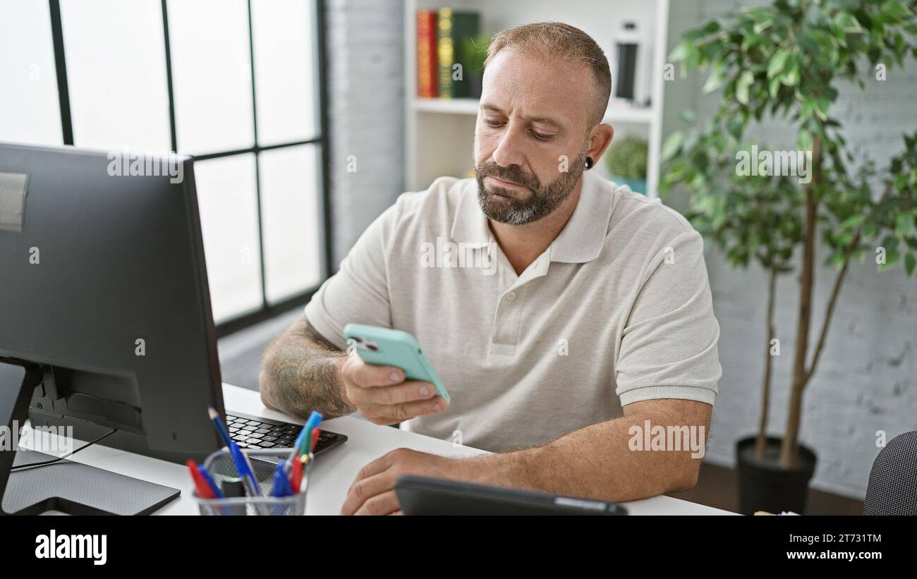 Attractive young business pro acing success as boss man at work - handsome male worker indoors ...
