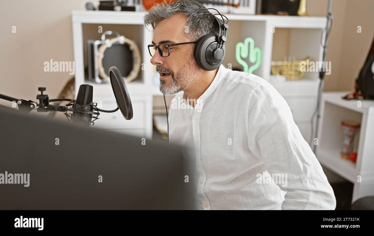 Attractive, grey-haired young hispanic man passionately lighting up the ...