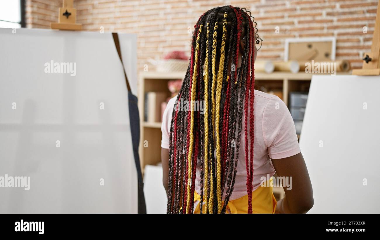 African american artist - a woman of power, standing back to easel at ...