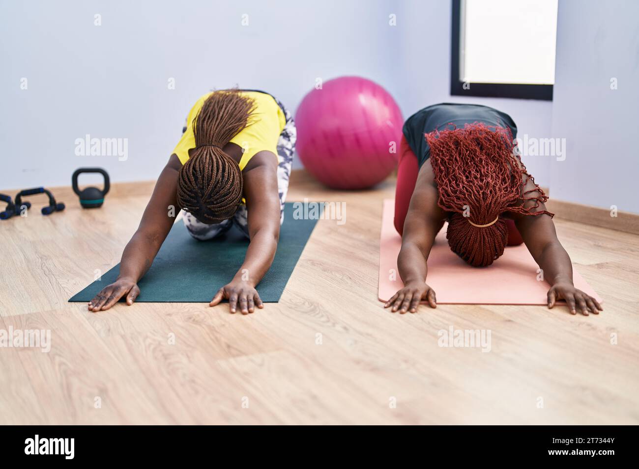 African american women stretching back at sport center Stock Photo - Alamy