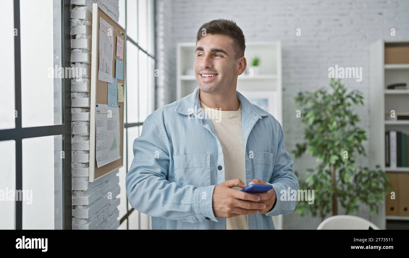 Confident young hispanic business worker joyfully casting his gaze out ...