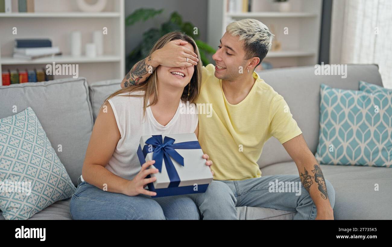 Beautiful couple surprise with birthday gift at home Stock Photo - Alamy