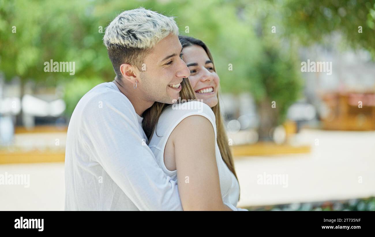 Beautiful couple smiling confident hugging each other at park Stock ...