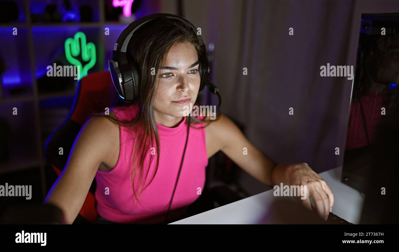 Young beautiful hispanic woman streamer playing video game using ...
