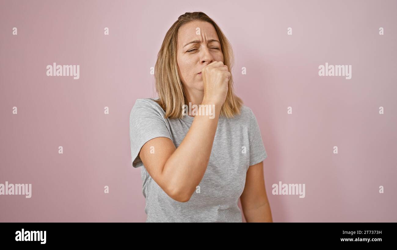 Caught a chill? beautiful young blonde woman coughing, showing flu-like ...
