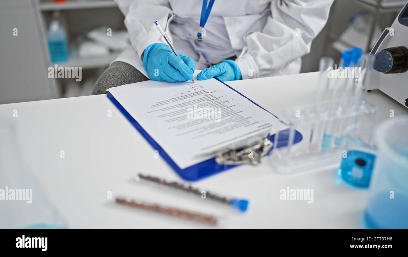 Inside the buzz of the lab, hands of dedicated woman scientist working ...
