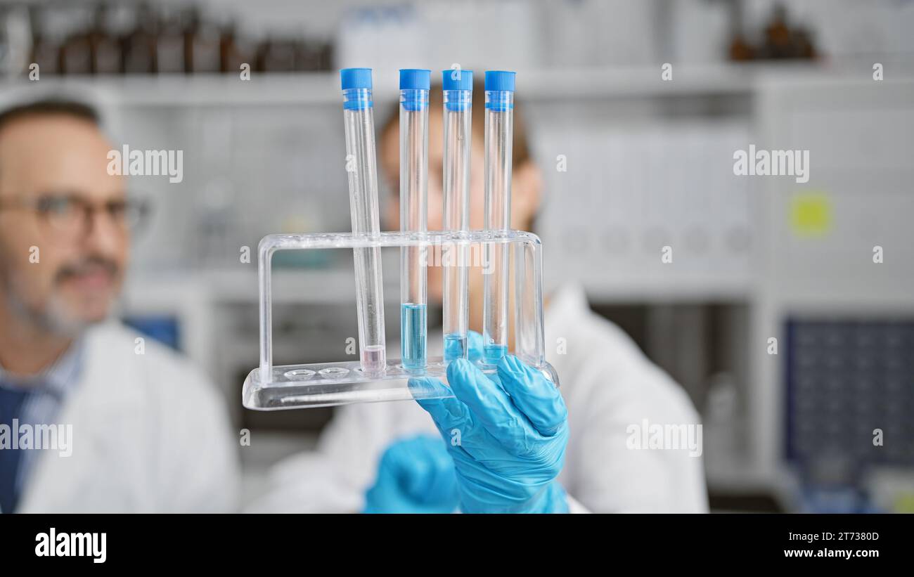 Two smiling scientists, partners in science, working together in a lab ...