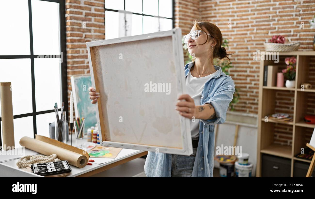 Young woman artist smiling confident looking draw at art studio Stock ...