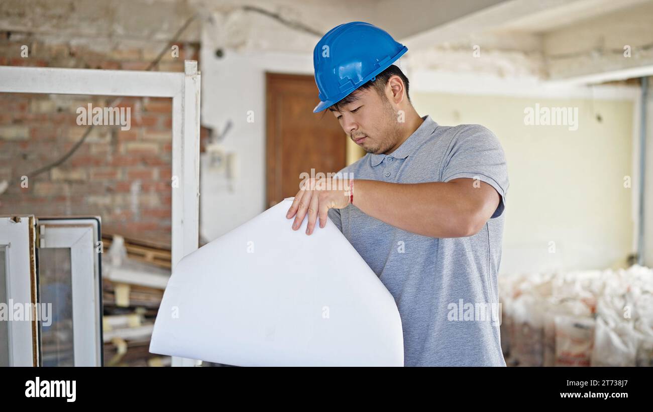 architect reading house project at construction site Stock Photo - Alamy