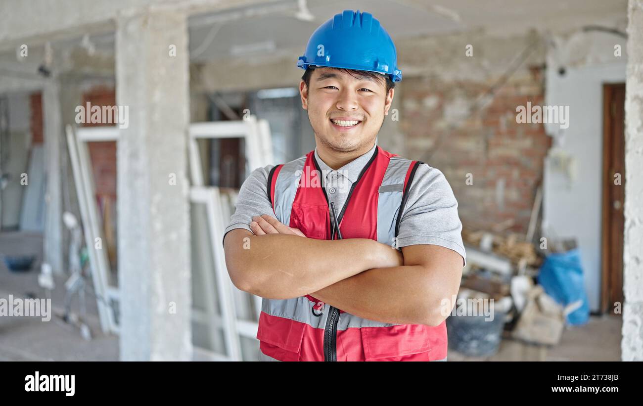 builder smiling confident standing with arms crossed gesture at ...
