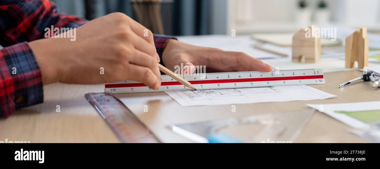 Closeup of architect engineer hand using ruler to mature and draw a ...