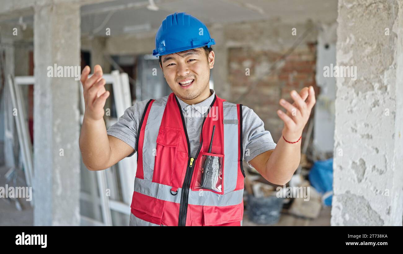 builder smiling confident speaking at construction site Stock Photo - Alamy