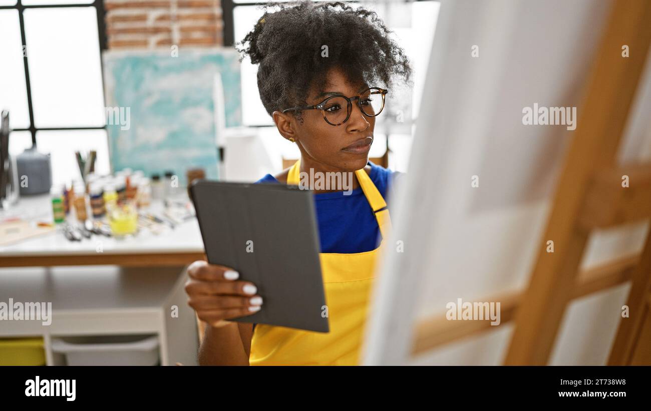 African american woman artist looking touchpad drawing at art studio ...